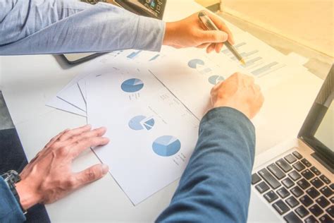 Premium Photo Colleagues Working Over Graph In Office