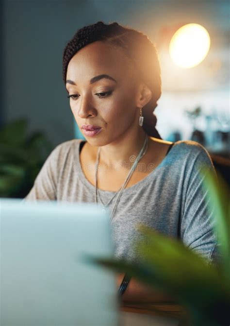 Working Late Into The Night A Young Woman Using Her Laptop While Working Late In Her Office