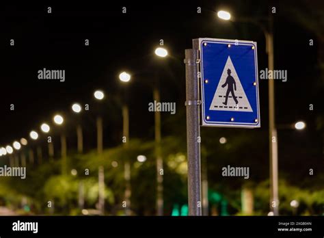 Illuminated Pedestrian Crossing Sign At Night City Street Lightning