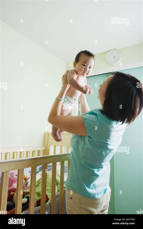 Mother Lifting Baby Crib Hi Res Stock Photography And Images Alamy