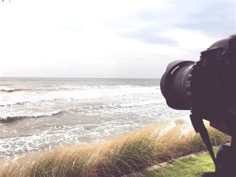 Premium Photo Close Up Of Camera On Beach Against Sky