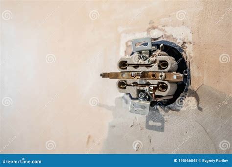 Disassembled Electrical Outlet In Detonation Wall With Bare Wires And Hallmarks During Repair In