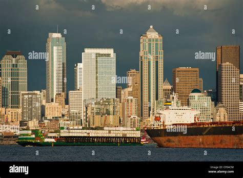 A Dramatic Sunset Highlights The Beautiful Seattle Waterfront Across