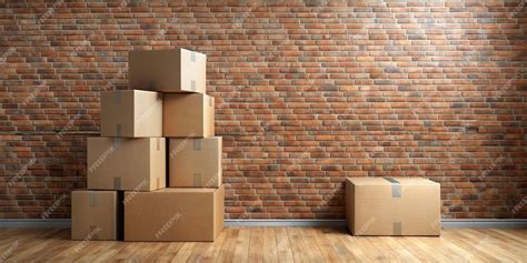 Stack Of Moving Boxes Leaning Against Brick Wall In Empty Room