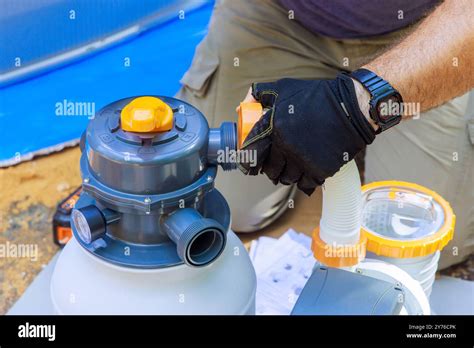 Swimming Pool Maintenance Workers Assemble Sand Filter System Tank