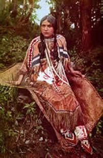 This Is A Woman Wearing A Deerskin Dress With Beads And Other