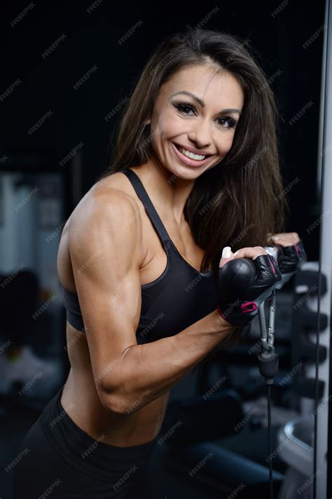 Premium Photo Sexy Athletic Young Girl Training Arms In Gym