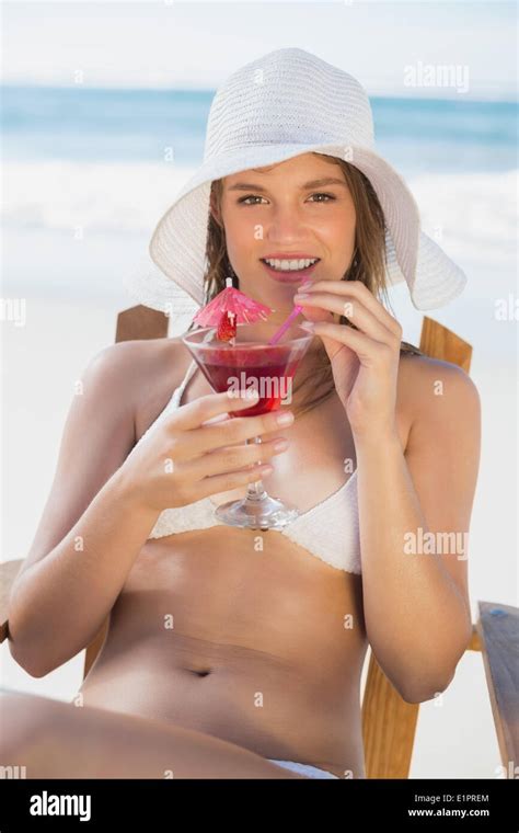 Pretty Blonde Relaxing In Deck Chair On The Beach With Cocktail Stock