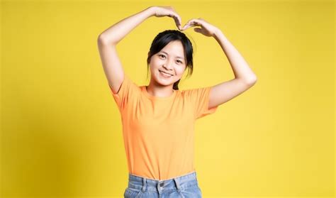 Premium Photo Asian Girl Posing On Yellow Background