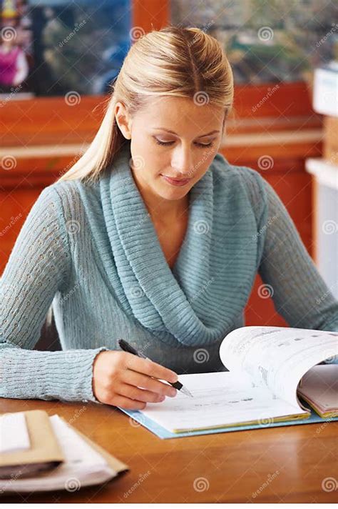 Grading Papers A Young Teacher Marking Homework In Her Office Stock