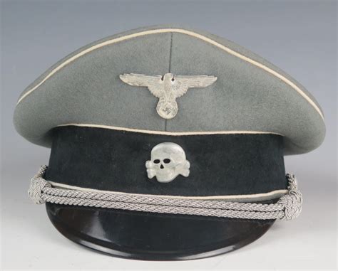 A Ww2 German Waffen Ss Officers Peaked Cap With Metal National Emblem