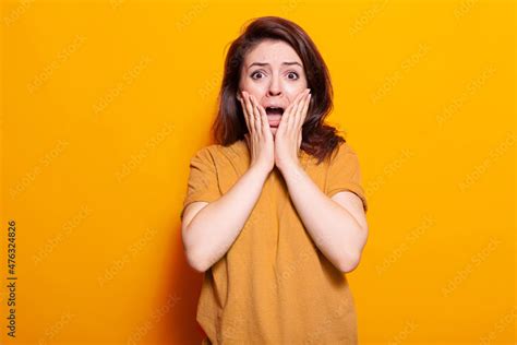 Portrait Of Terrified Person Holding Hands On Face To Pose On Camera
