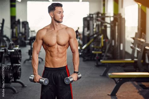 Fitness Man With Naked Torso Working Out With Dumbbells During Training