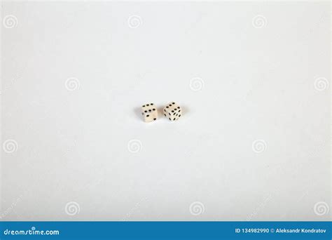 Two Very Small Dice Near Each Other On A Large White Background Stock