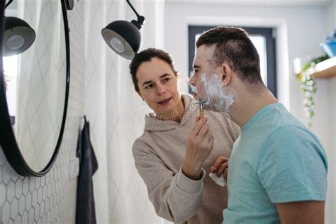 Mother Applying Shaving Foam On Sonand X27 S Face Young Man With Down