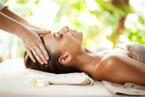 Young Woman Enjoying During Head Massage At Tropical Spa Resort Stock