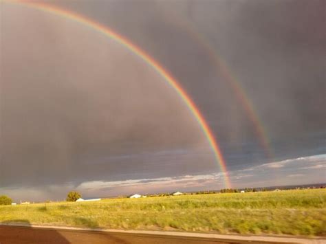 Premium Photo Scenic View Of Rainbow Over Grassy Field