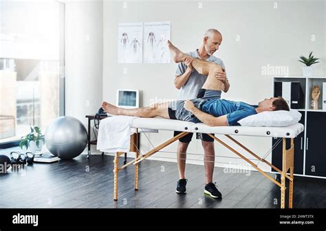 How Does It Feel Now Shot Of A Physiotherapist Treating A Patient