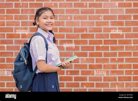 Thai Asian School Girl Teen Happy Smile In Uniform Handle Book And