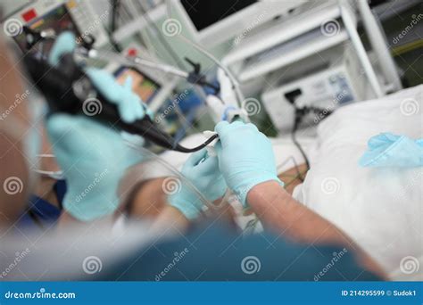 Endoscopic Examination Of Patient Performing By Male Doctor And Female Assistant In The Icu