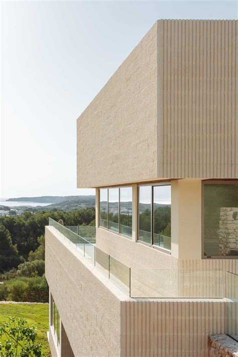 Fluted Concrete Walls Cut By Continuous Window Openings Define This