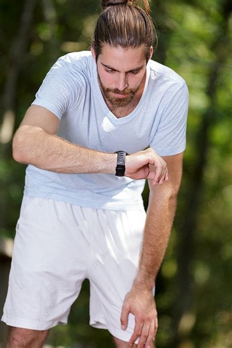 A Man Checking His Stopwatch Photo Background And Picture For Free
