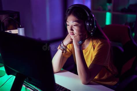 Chinese Woman Streamer Stressed Using Computer At Gaming Room Stock
