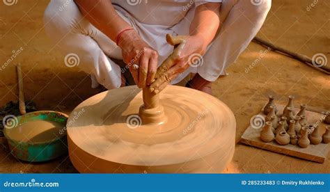 Skilled Hands Of Potter Shaping The Clay On Potter Wheel And Sculpting