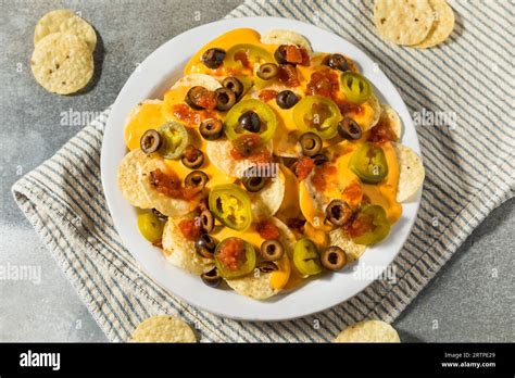 Homemade Basic Mexican Nachos With Cheese Jalapeno And Olives Stock