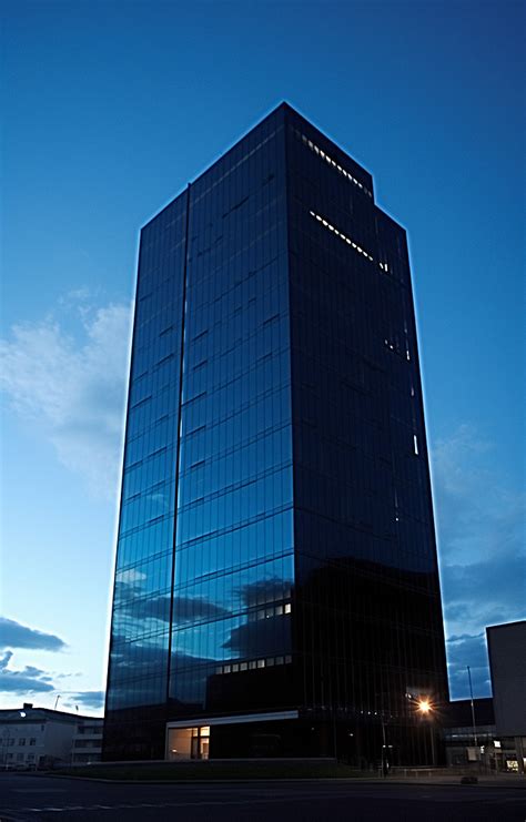 Large Building With A Small Building Behind It Background Wallpaper