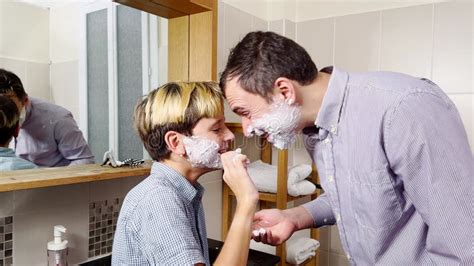 Dad With Son Shaving Foam On Face Touching Foreheads Laughing Stock