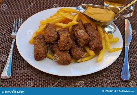 Cevapi Or Mici Mititei With French Fries Or Chips With Mustard On A
