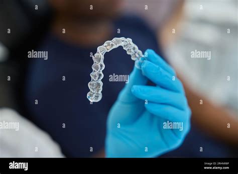 Dental Aesthetic Clinic Worker Holding Clear Aligners To Straight Teeth