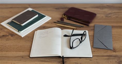A Notebook Pen Glasses And Notebook On A Table Photo Desk Image On Unsplash
