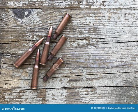 54mm Rifle Ammo Casings And Bullets On A Wooden Background Stock Image
