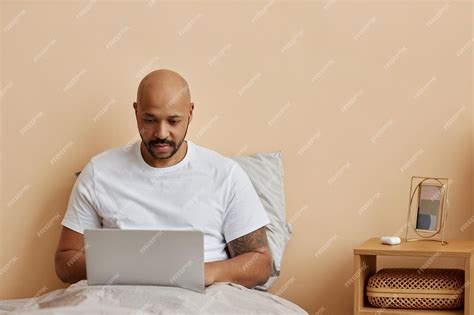 Premium Photo Adult Black Man Using Laptop In Bed In Morning