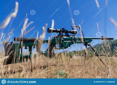 A Green Military Sniper Rifle With A Scope For Long Distance Tactical