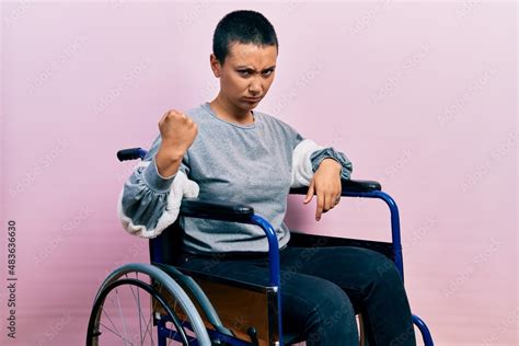 Beautiful Hispanic Woman With Short Hair Sitting On Wheelchair Angry