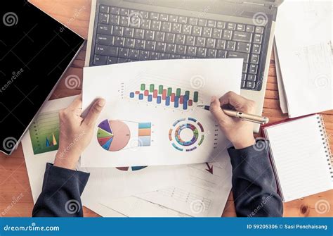 Businesswoman Analyzing Business Report With Charts And Graph Stock