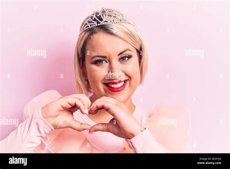 Beautiful Blonde Plus Size Woman Wearing Pincess Tiara With Diamonds Over Pink Background