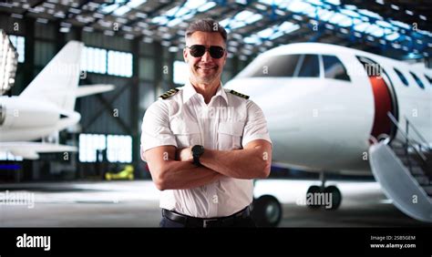 Private Jet Captain Pilot In Uniform Small Airplane At Airport Stock