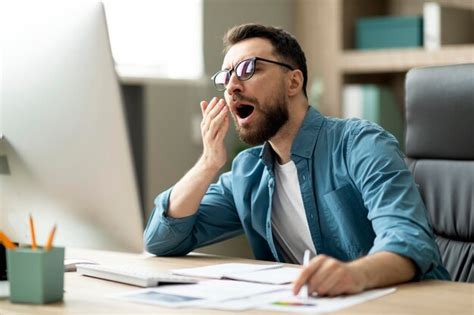 Premium Photo Portrait Of Sleepy Young Businessman Yawning At