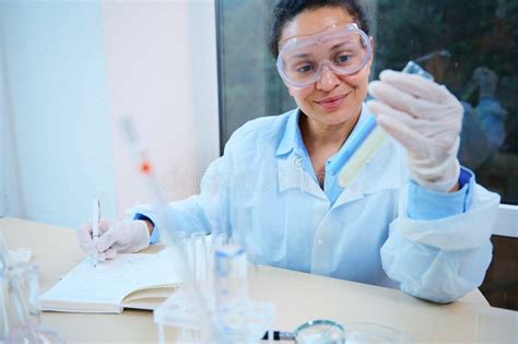 Multi Ethnic Woman Lab Technician Scientist Testing The Chemical