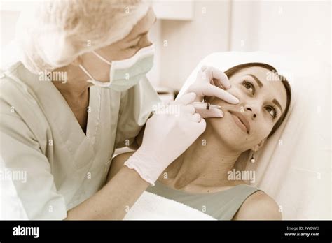 Young Woman Getting Injection For Facial Correction Procedure In
