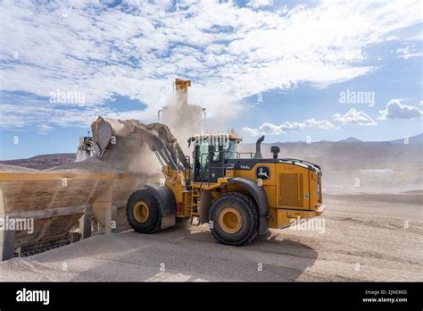 A Deere 744l Wheel Loader Dumping Aggregate Into A Hopper For The