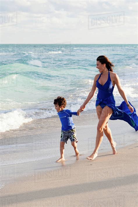 Caucasian Mother And Son Walking On Beach Stock Photo Dissolve
