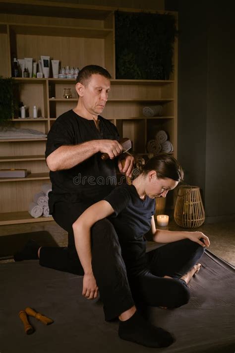 Male Master Giving Thai Toksen Massage To Girl In Massage Room A Girl