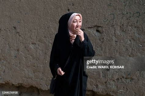 An Afghan Hazara Girl Gestures Along A Street In Dasht E Barchi In