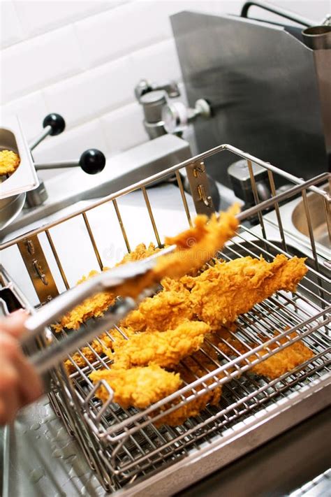 Cooking Breaded Chicken Slices In The Kitchen In A Restaurant Stock