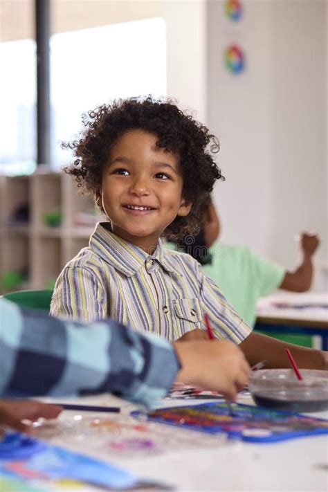Classroom Portrait Of Smiling Male Elementary School Pupil In Art Class